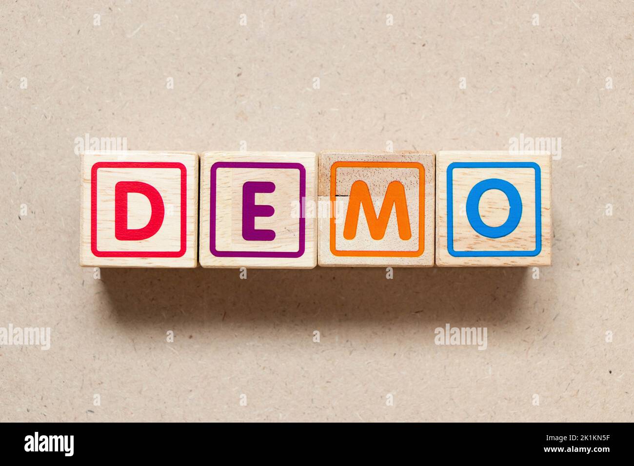Color letter block in word demo on wood background Stock Photo - Alamy