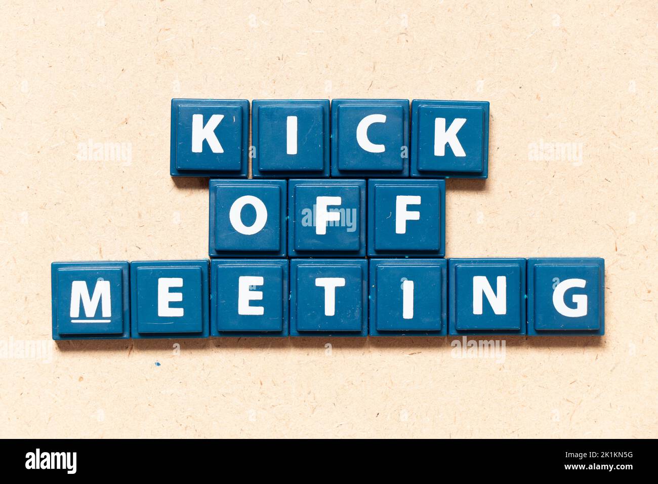 Tile letter in english word kick off meeting on wood background Stock ...