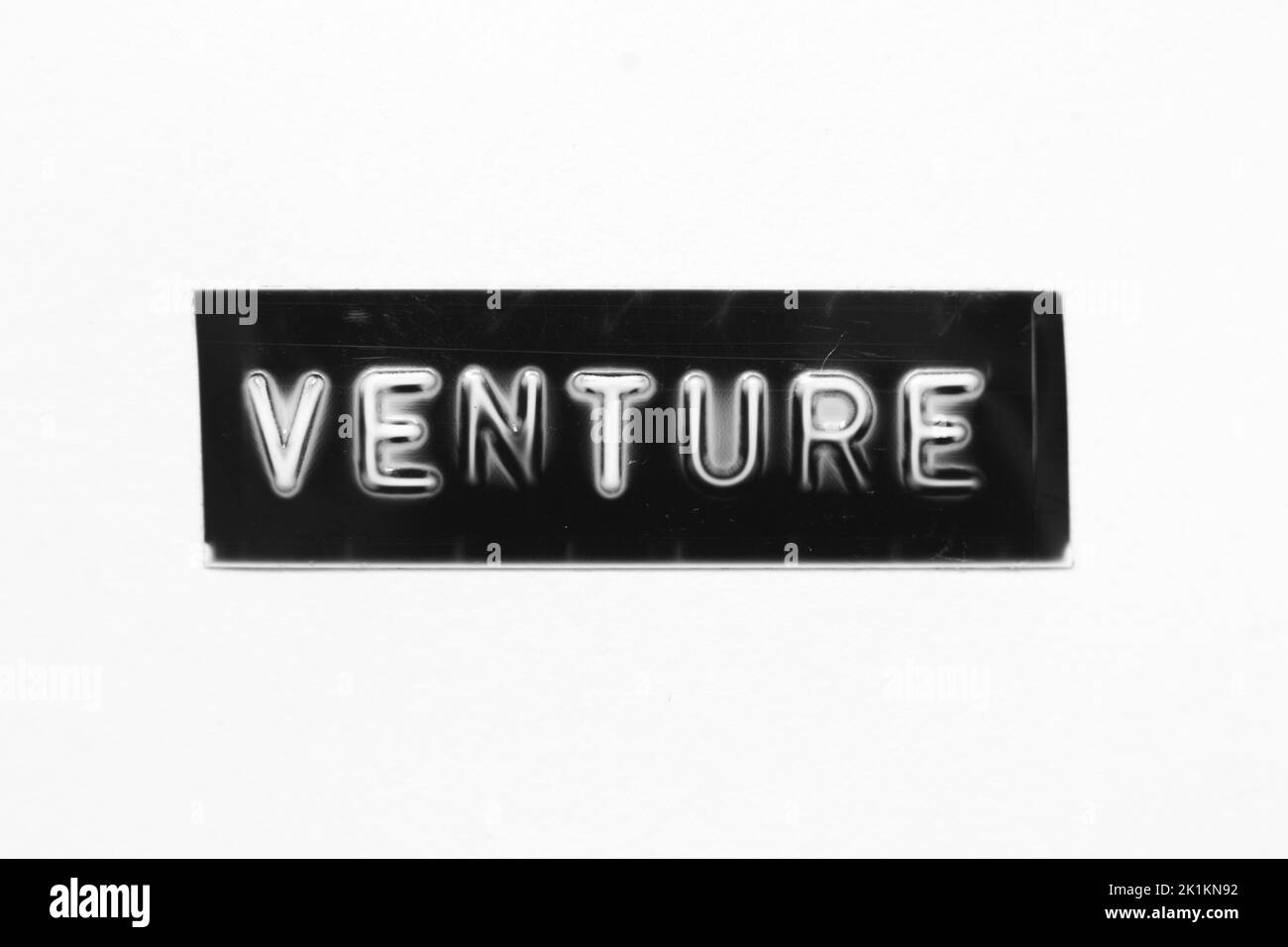 Black color banner that have embossed letter with word venture on white ...