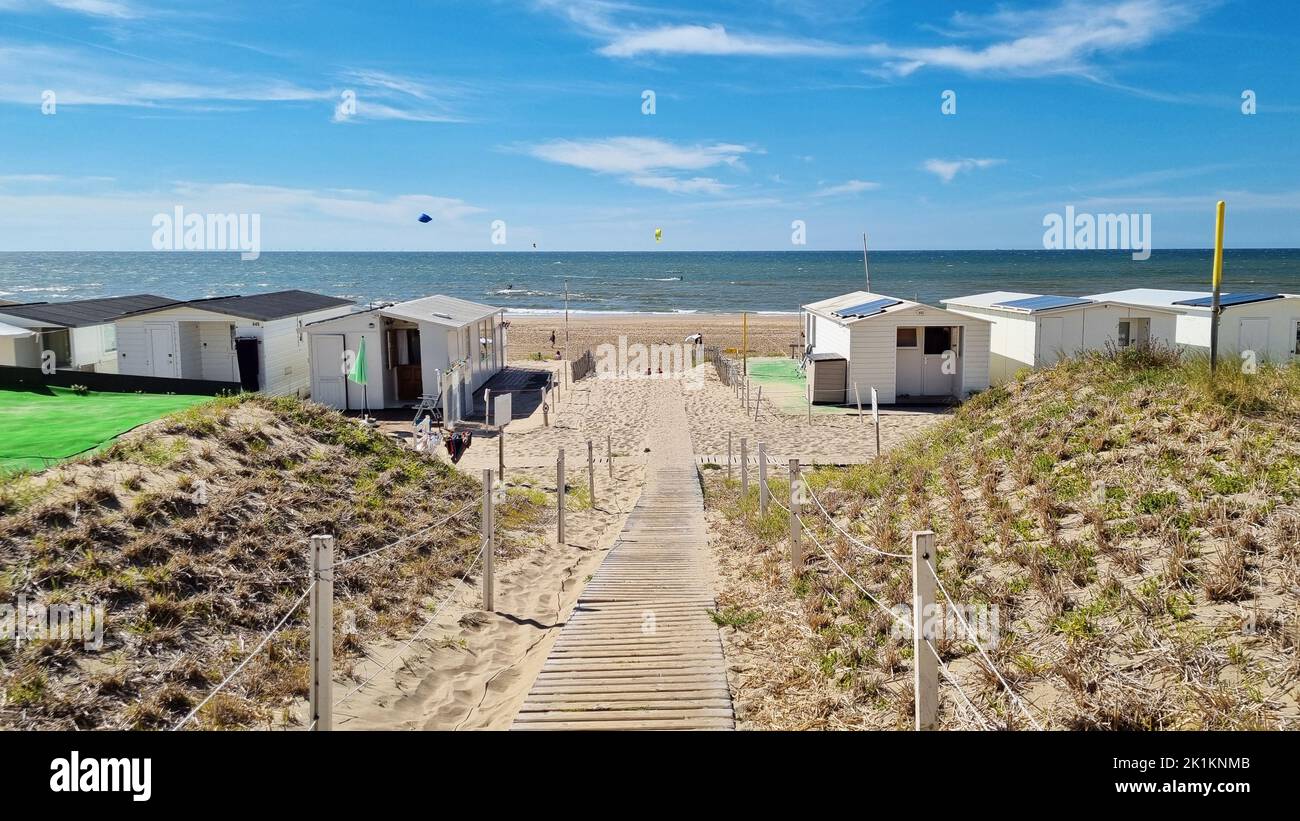 View from dunes on North Sea city beach on a sunny summer weekend ...
