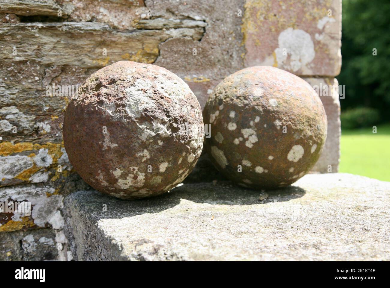 A pair of old cannon balls on the castle ramparts Stock Photo - Alamy