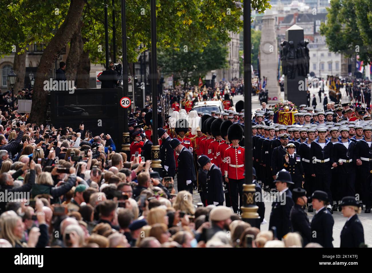 Crowds watch as the State Gun Carriage carries the coffin of Queen Elizabeth II, draped in the ...