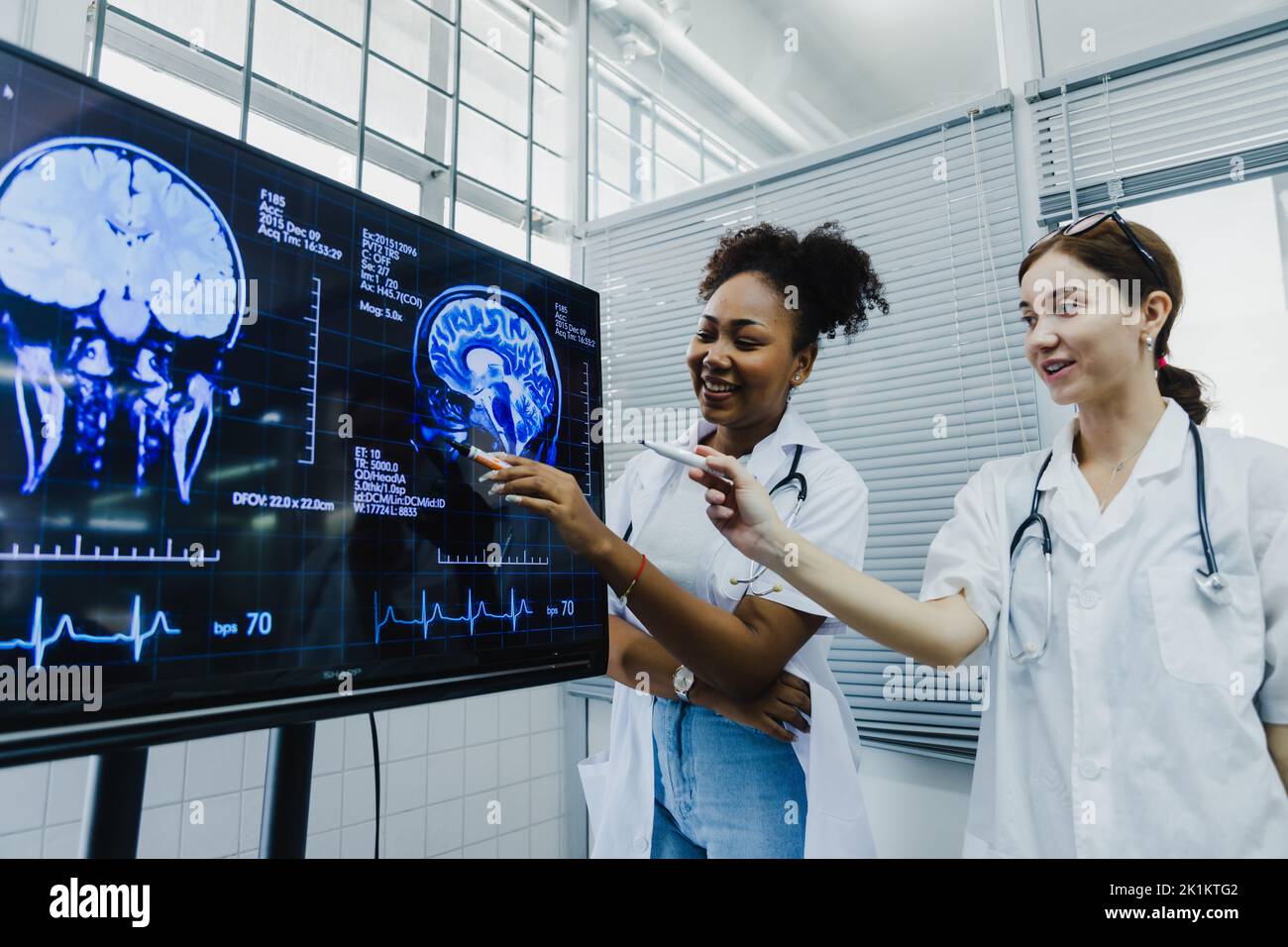 Team of female doctor check on scan results paper and looking at ...