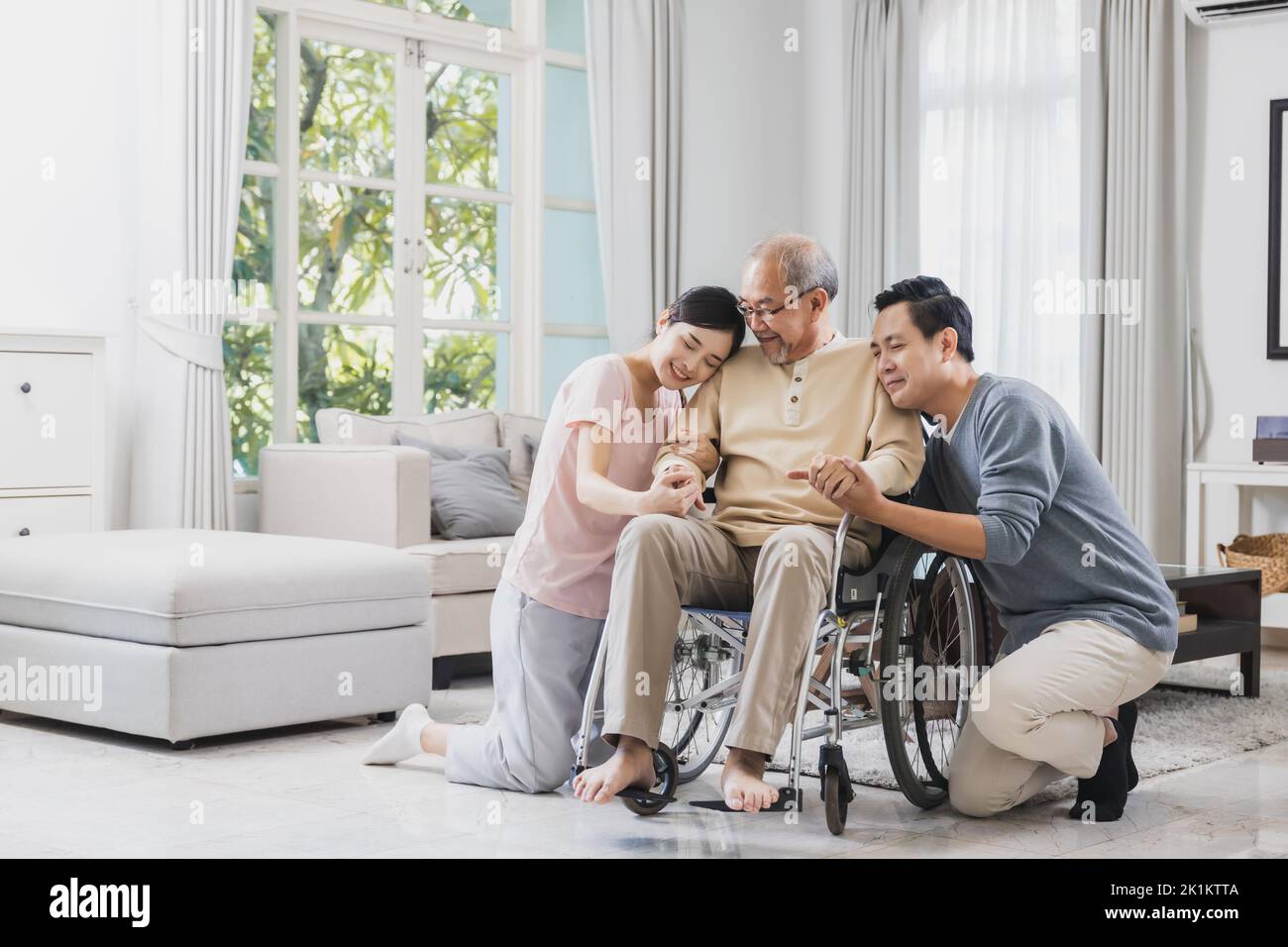 Happy family of senior with beautiful daughter, her husband and grandson take care old man ...