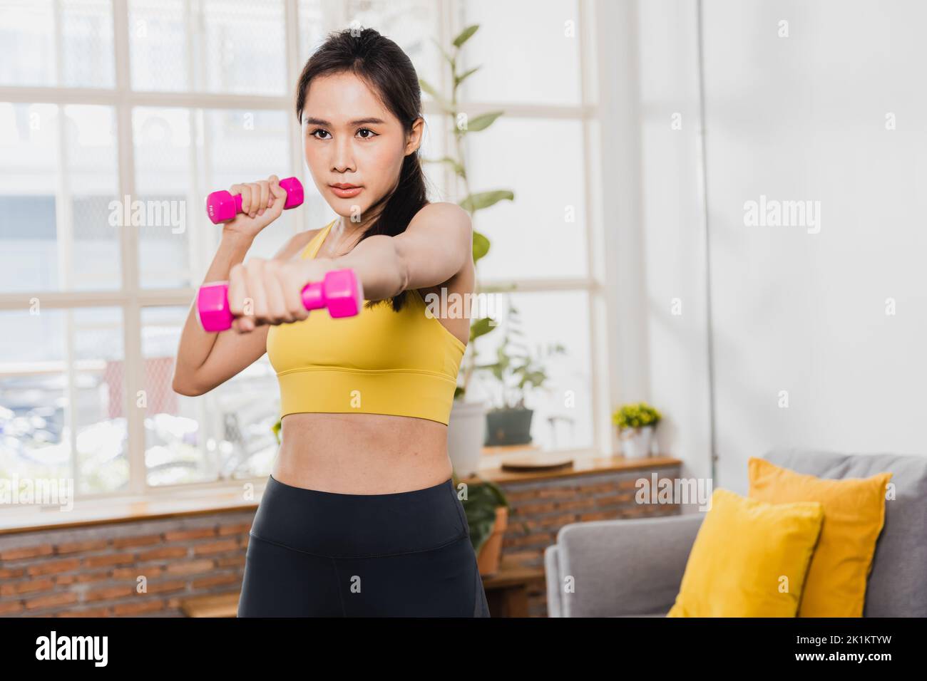 Asian beautiful woman in sport wear exercise and work out at home with ...