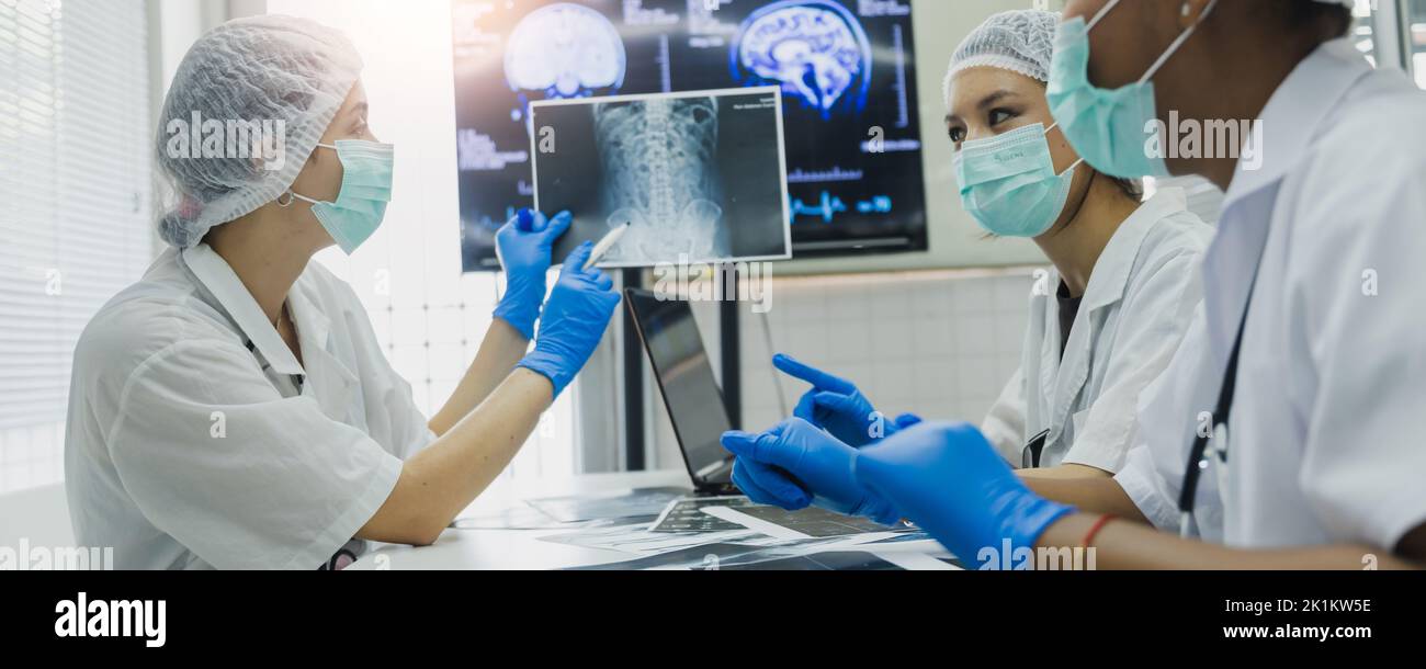 Team of female doctor check on scan results paper and looking at ...