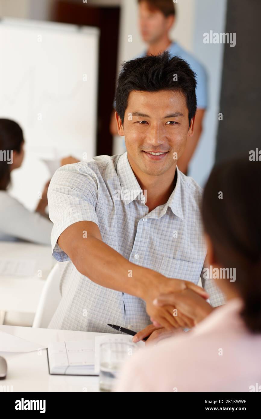 Great to meet his new partner. an asian man shaking hands with a ...