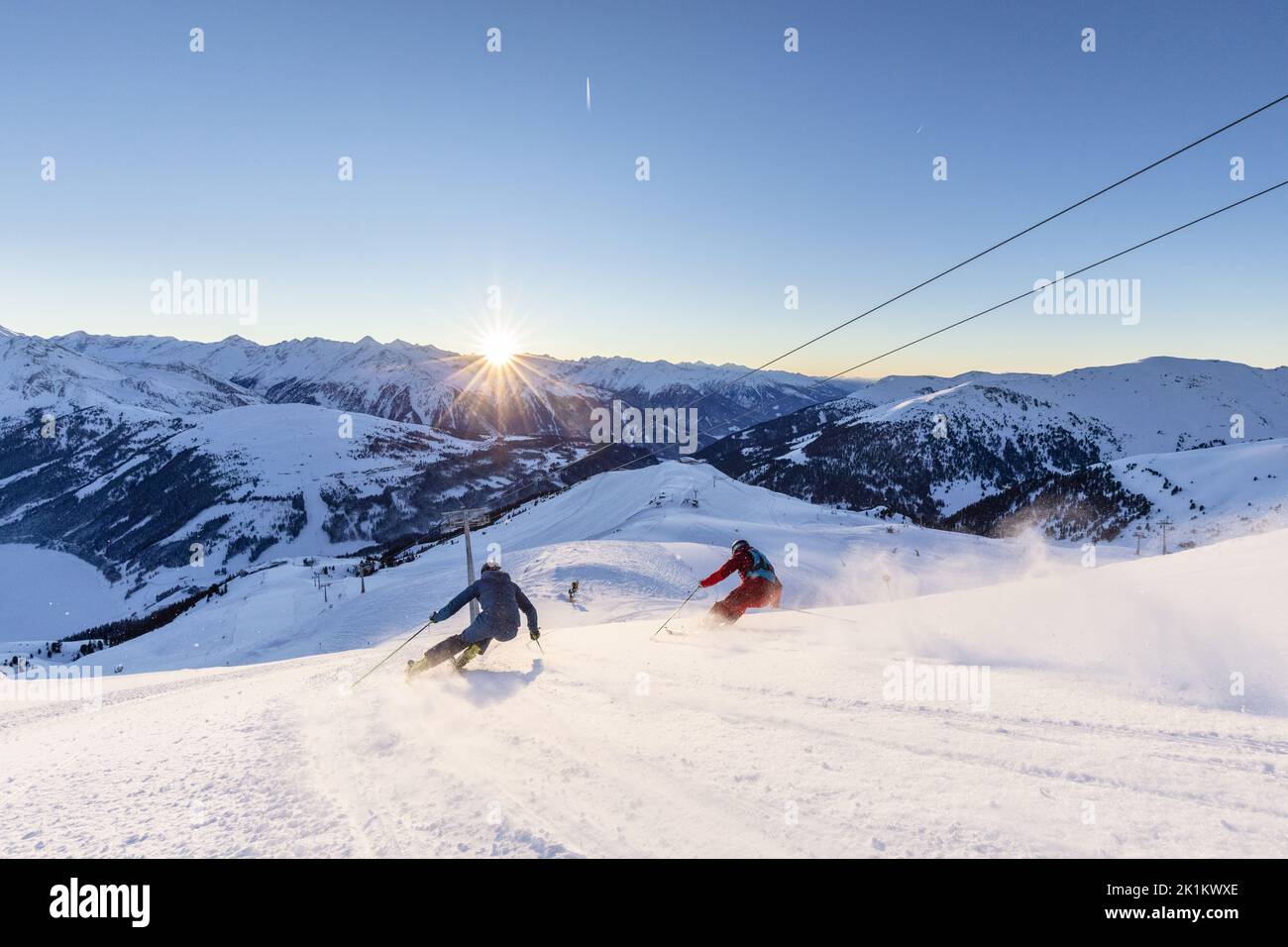 The people skiing downhill in the high snowy mountains Stock Photo - Alamy