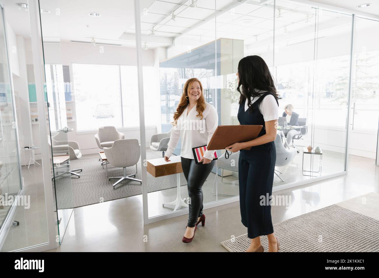 Two women talking in modern office Stock Photo - Alamy