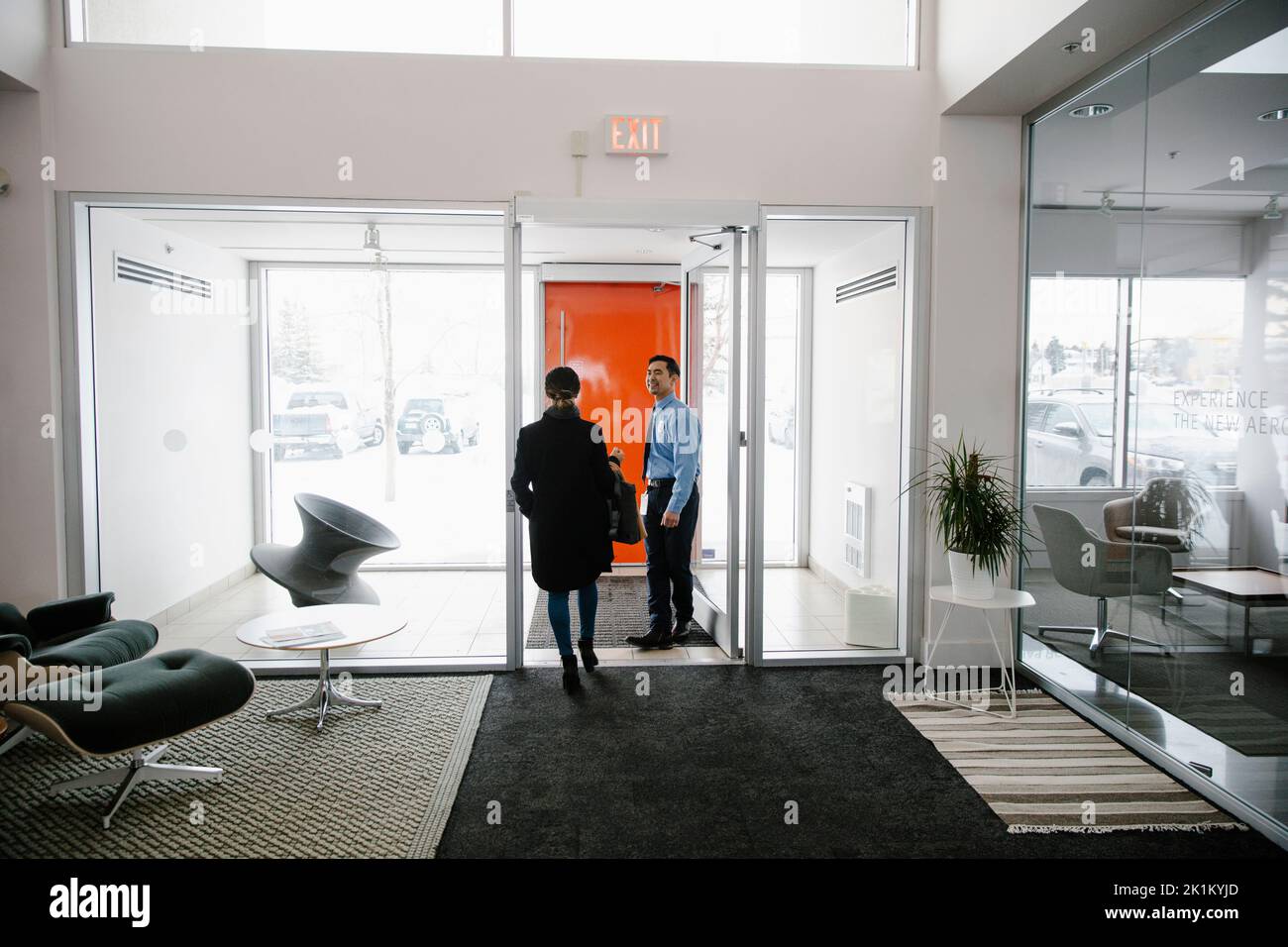 Woman opening door man hi-res stock photography and images - Alamy