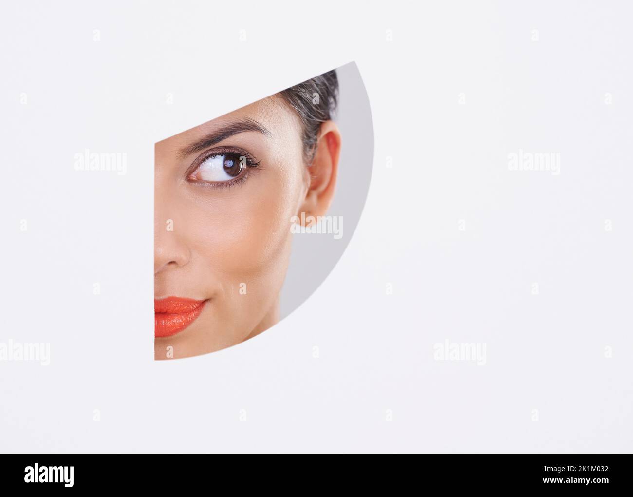 Guess the shape. a beautiful young woman through a cut out shape Stock ...