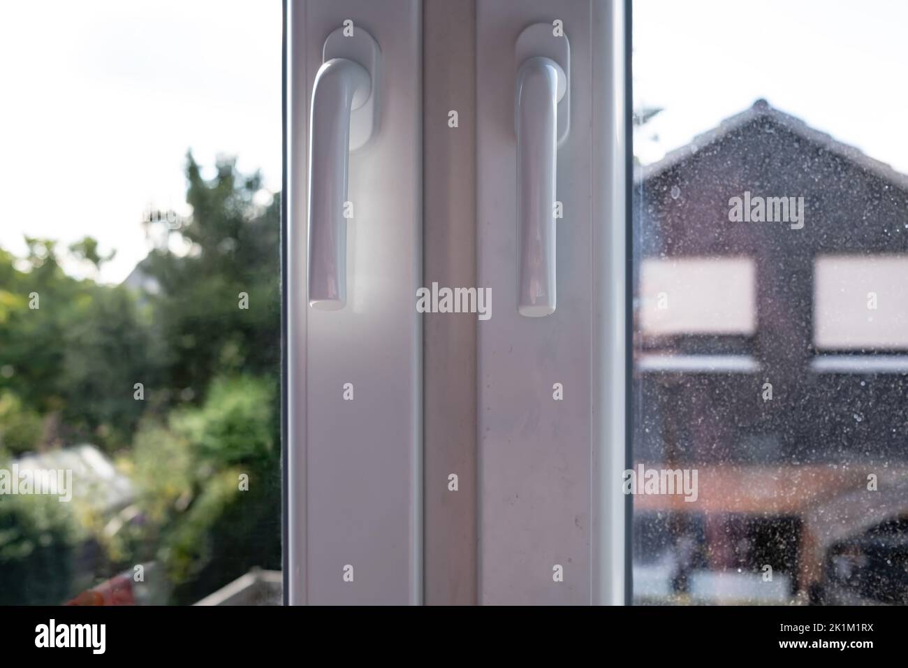Closed white PVC window with two sashes, with dirty glass, through ...