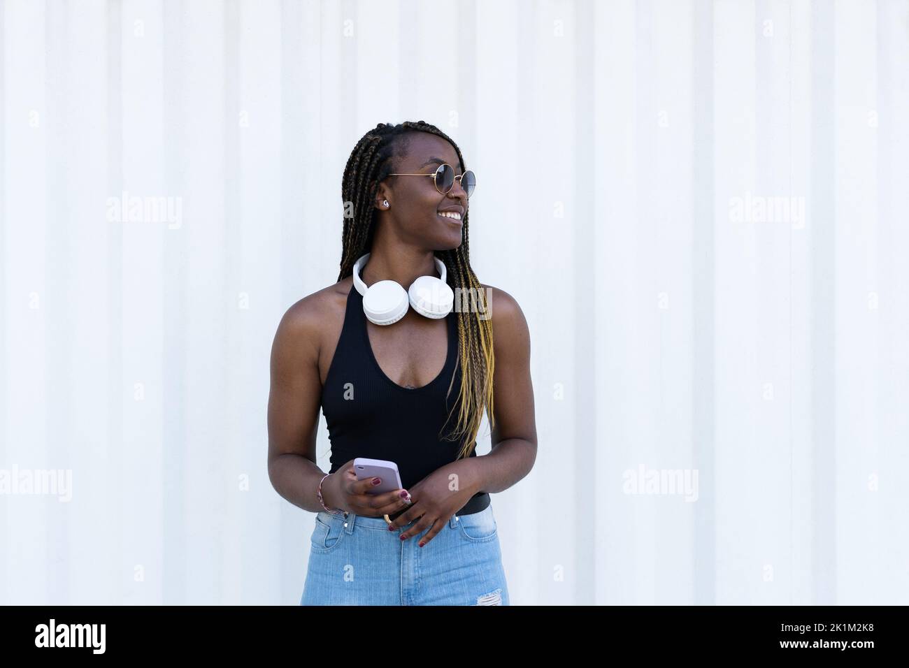 Portrait of a cheerful generation Z smartphone user girl with a large ...