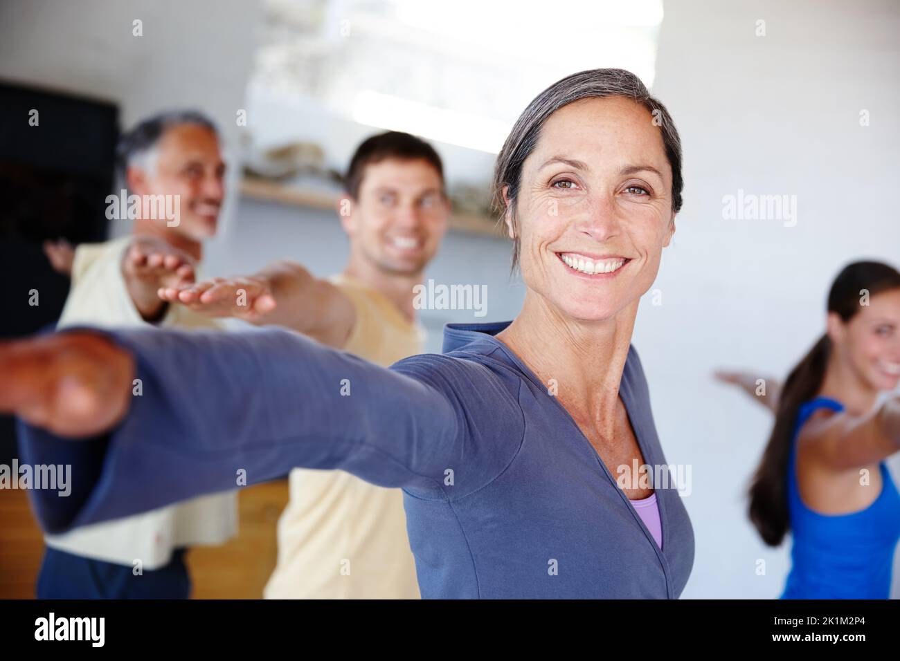 Health makes her happy. A group of people taking a class together at ...