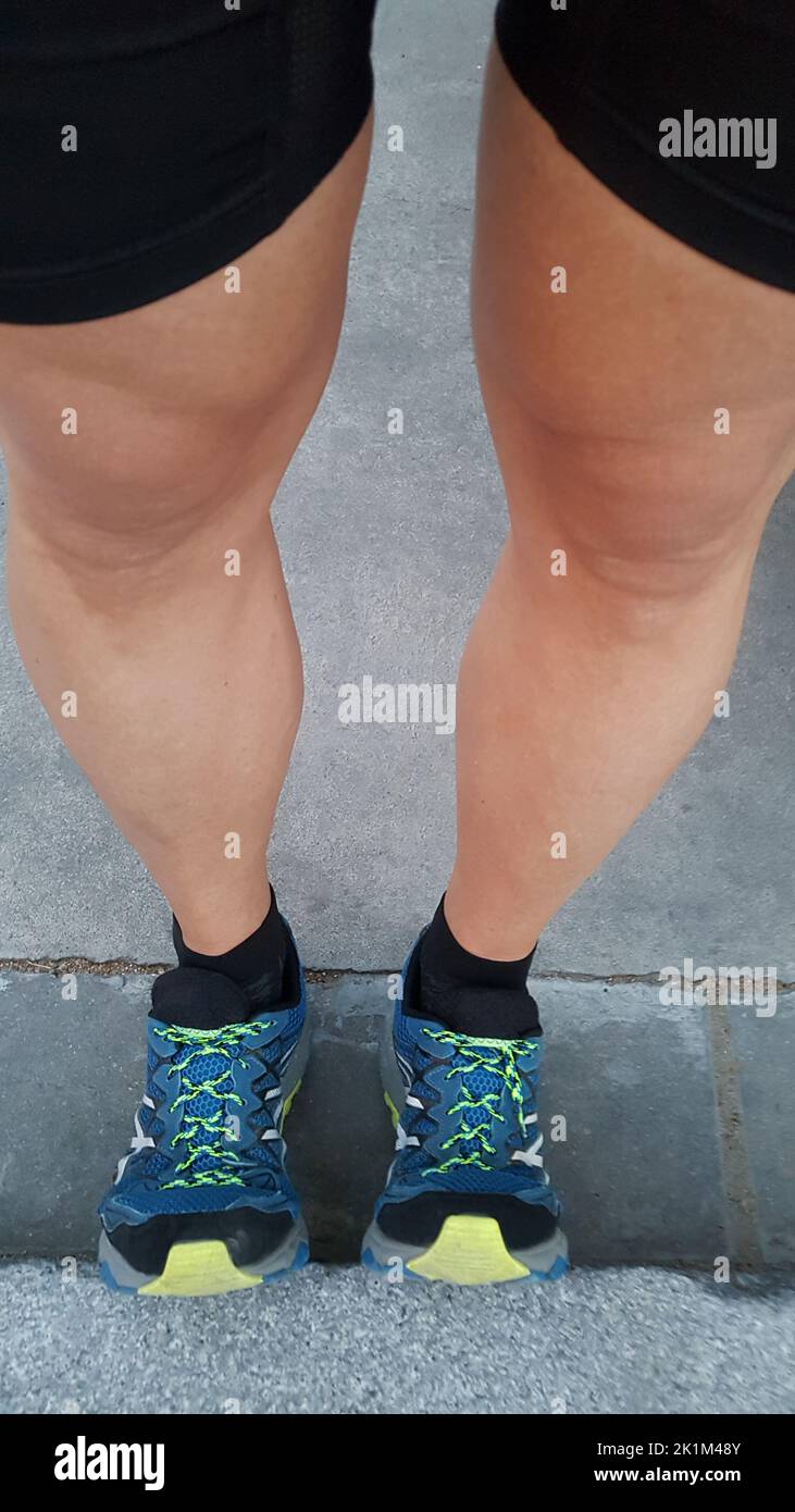 Man's legs stretching before going for a run Stock Photo - Alamy