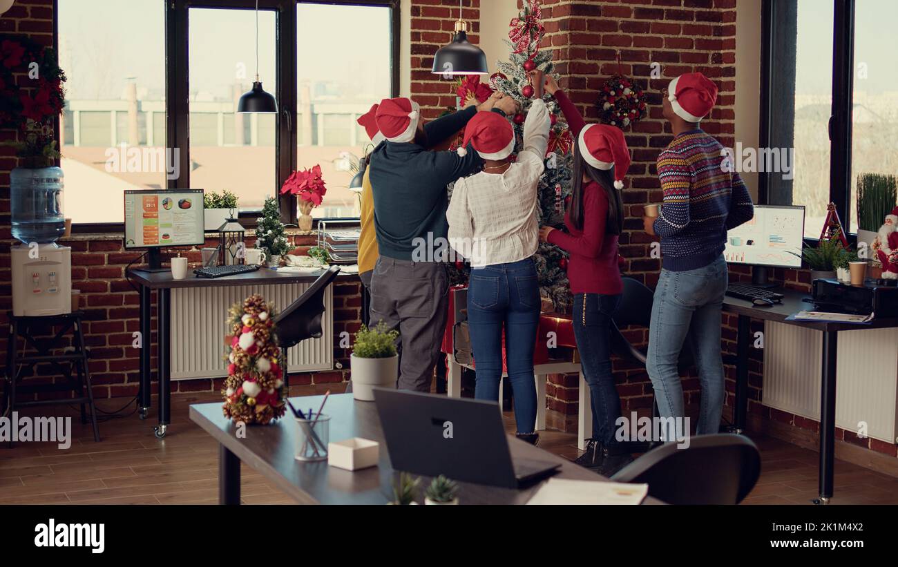 Diverse group colleagues decorating christmas hi-res stock photography ...