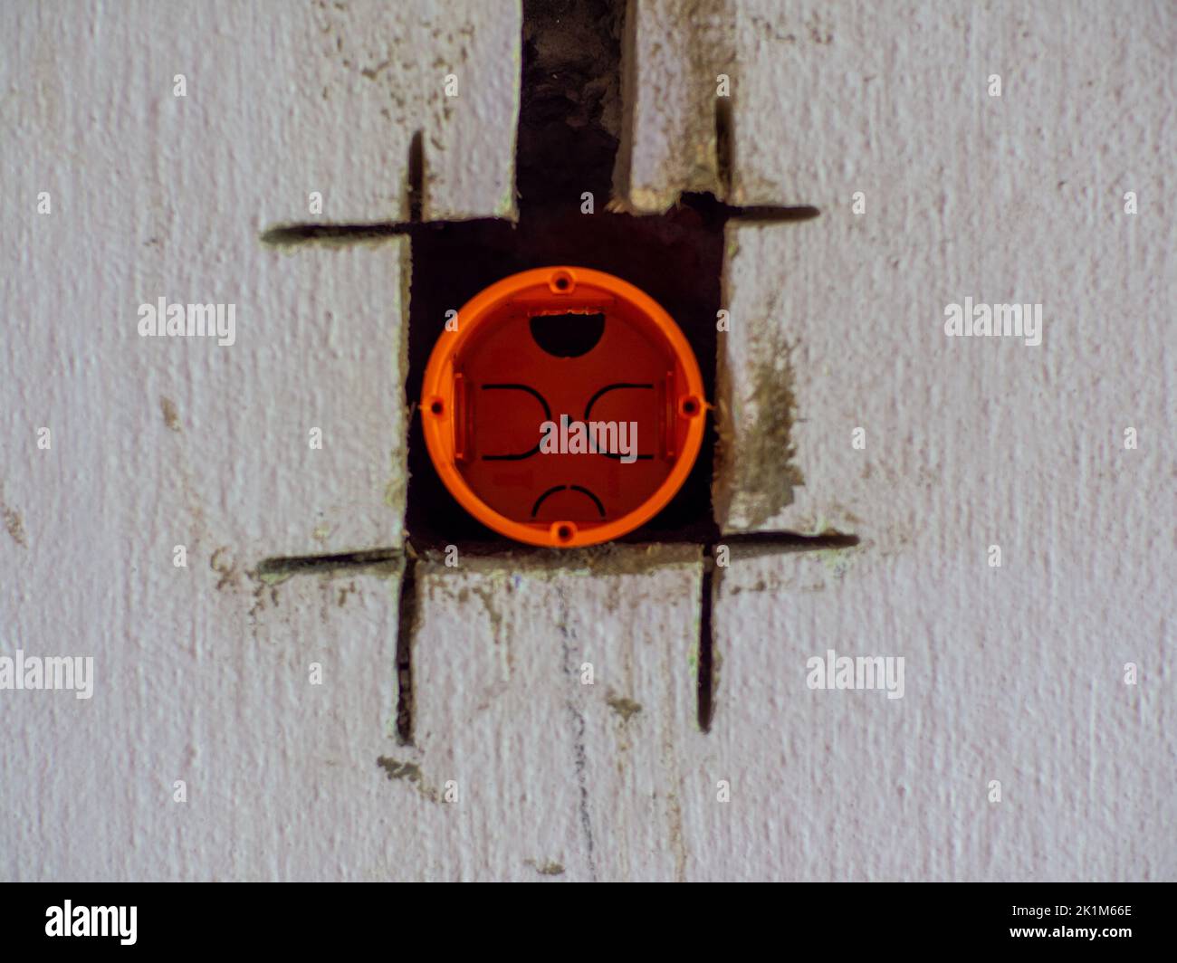 Plastic backbox for socket or switch inserted into the drilled hole on ...