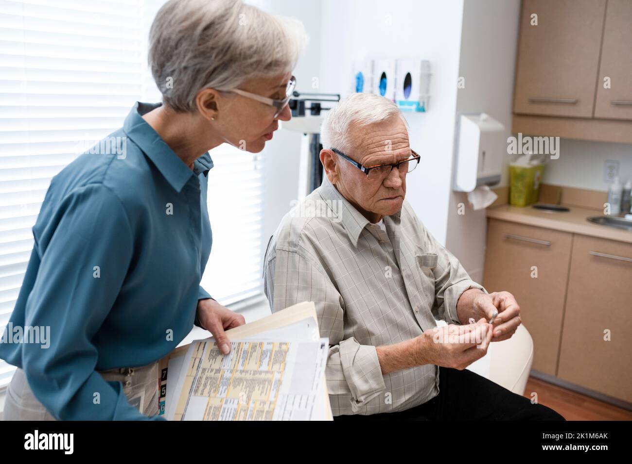 Doctor helping patient hi-res stock photography and images - Alamy