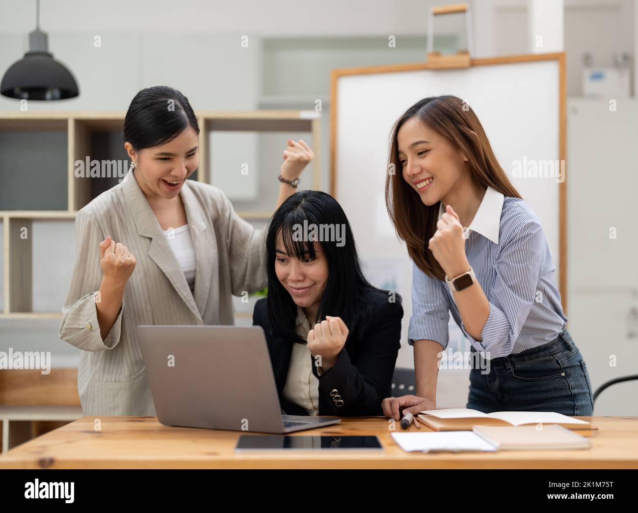 Happy business asian people are keeping arms raised hi five and ...