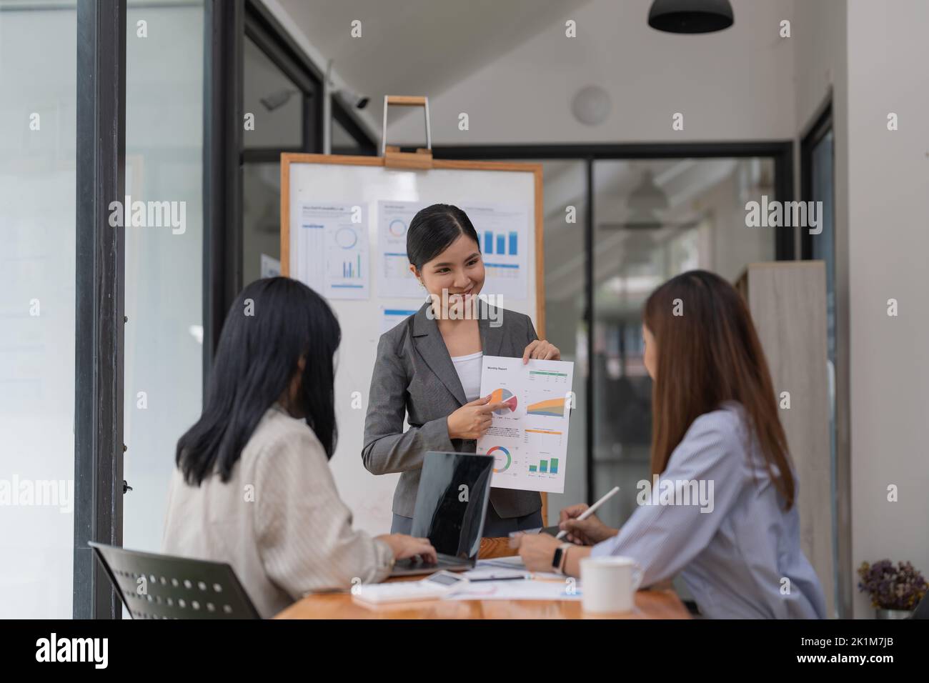 Business asian presenting analytical report while working together with ...