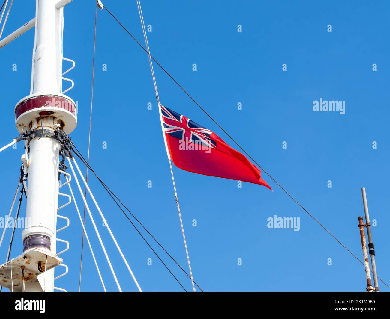 red ensign flying above a boat alongside the dock in Great Britain ...