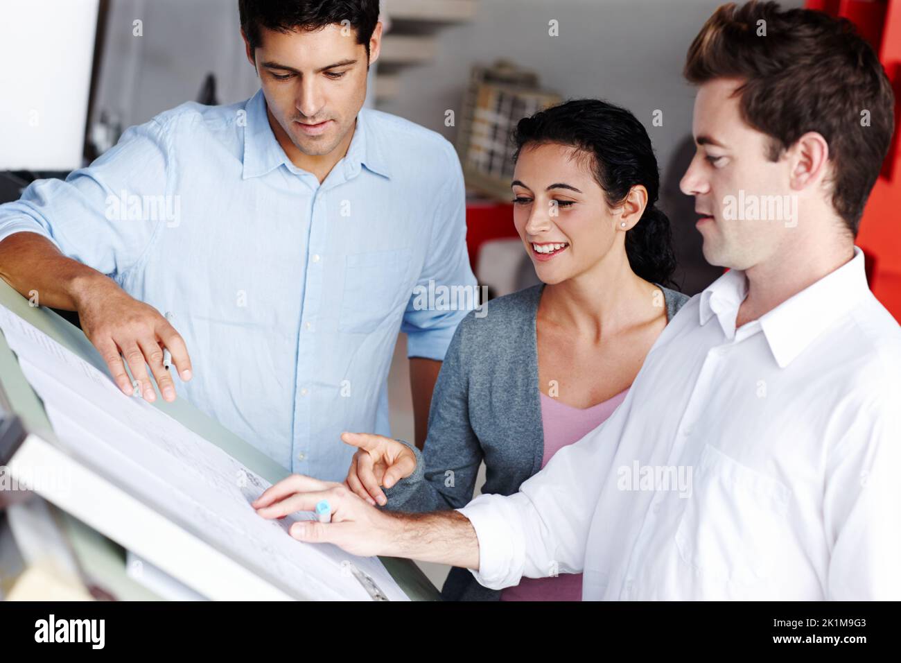 Perfecting their design together. Three talented architects working on ...