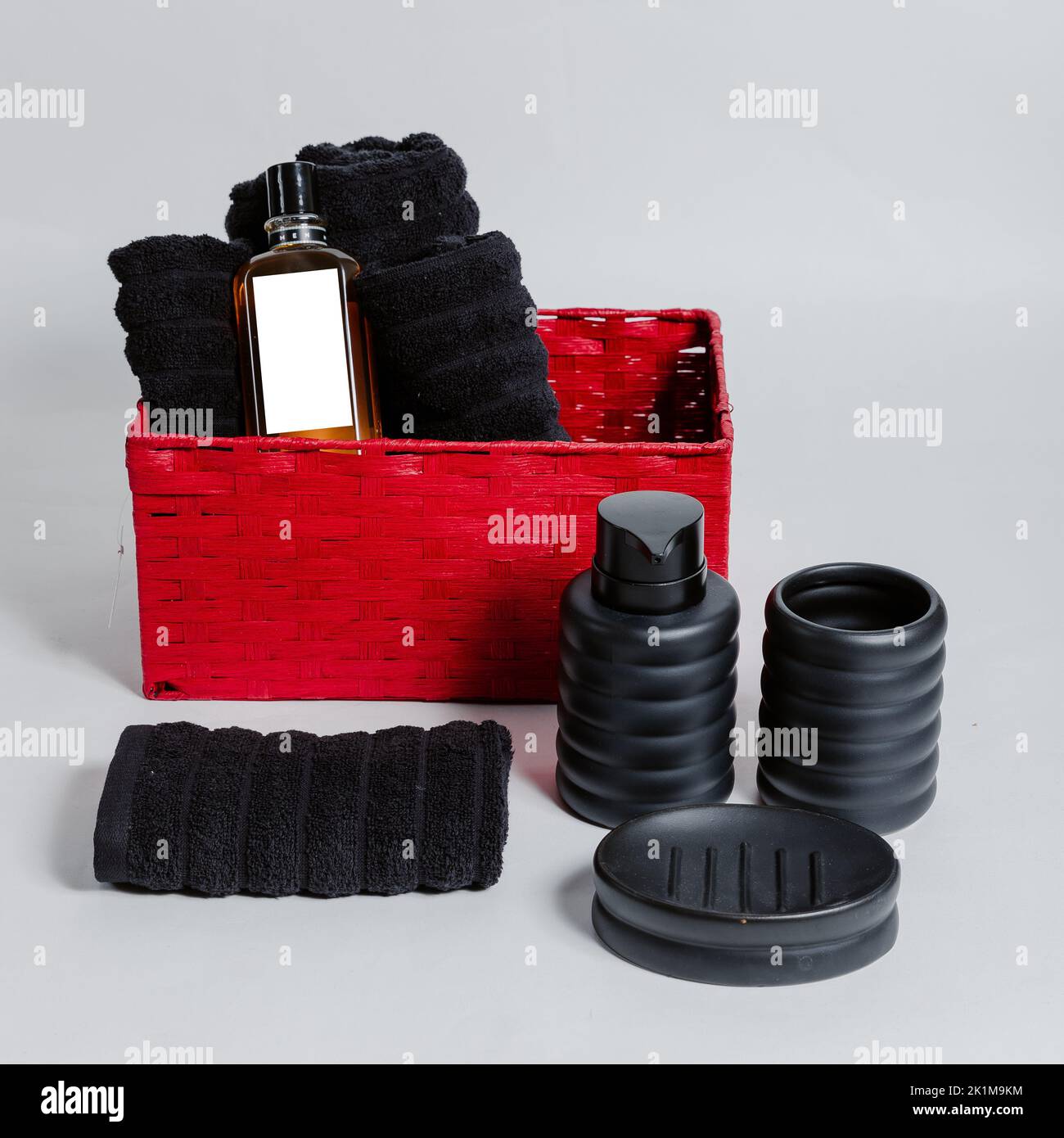 A set of men's hygiene kit that in a red basket displayed on a white ...