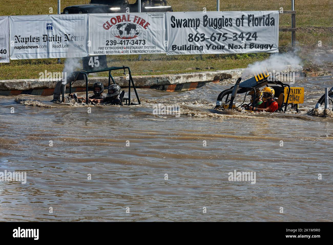 swamp buggies, racing, mostly submerged in water, contest, motion ...