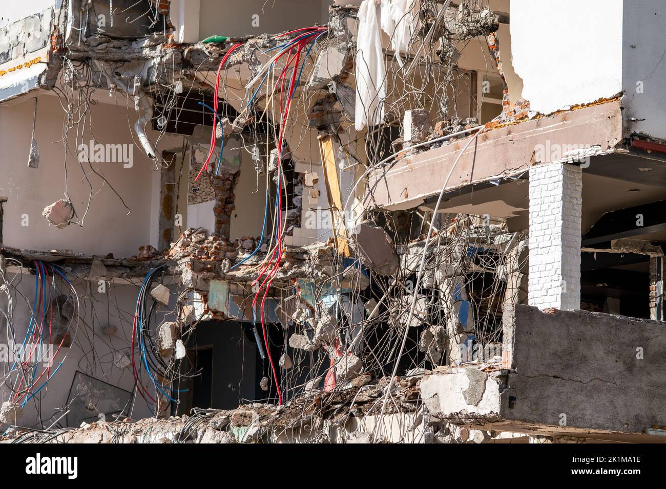 Demolished building and heap of debris. Pile of Stone, brick, rebar and ...