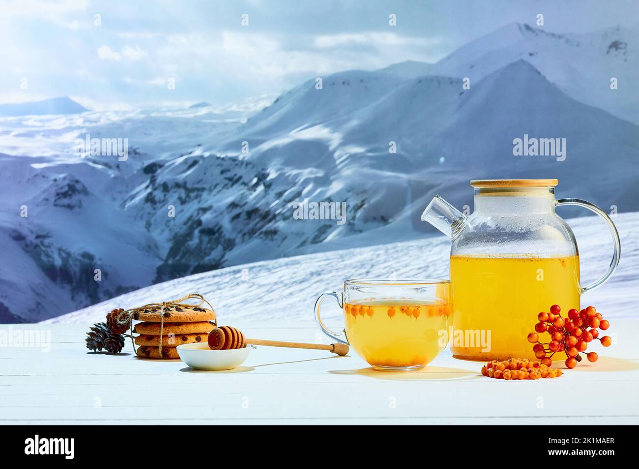 Tea with honey. Glass pot with fruit or berries tea, cakes, biscuits on ...