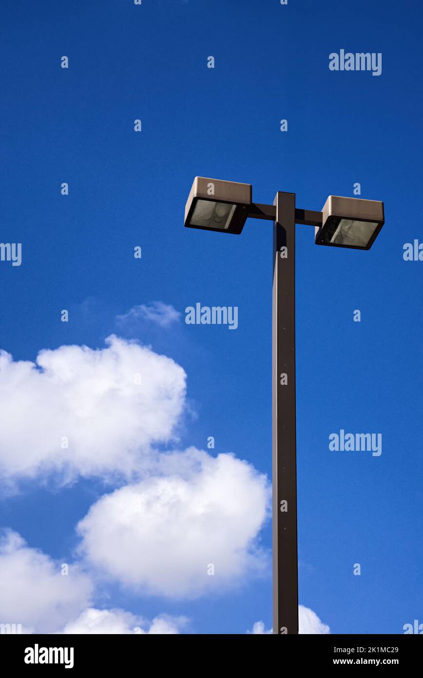 A low-angle view of a street light against the pure sky and clouds ...