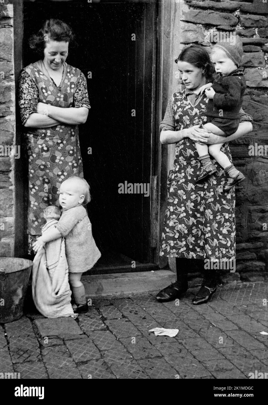 1930s, historical, welsh mining village...two women, wearing flower ...