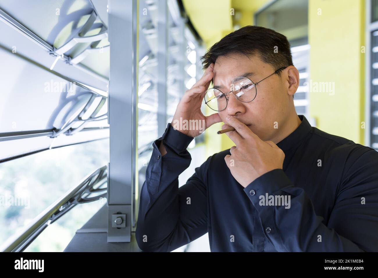 Asian businessman upset and sad in depression smoking cigarettes on ...