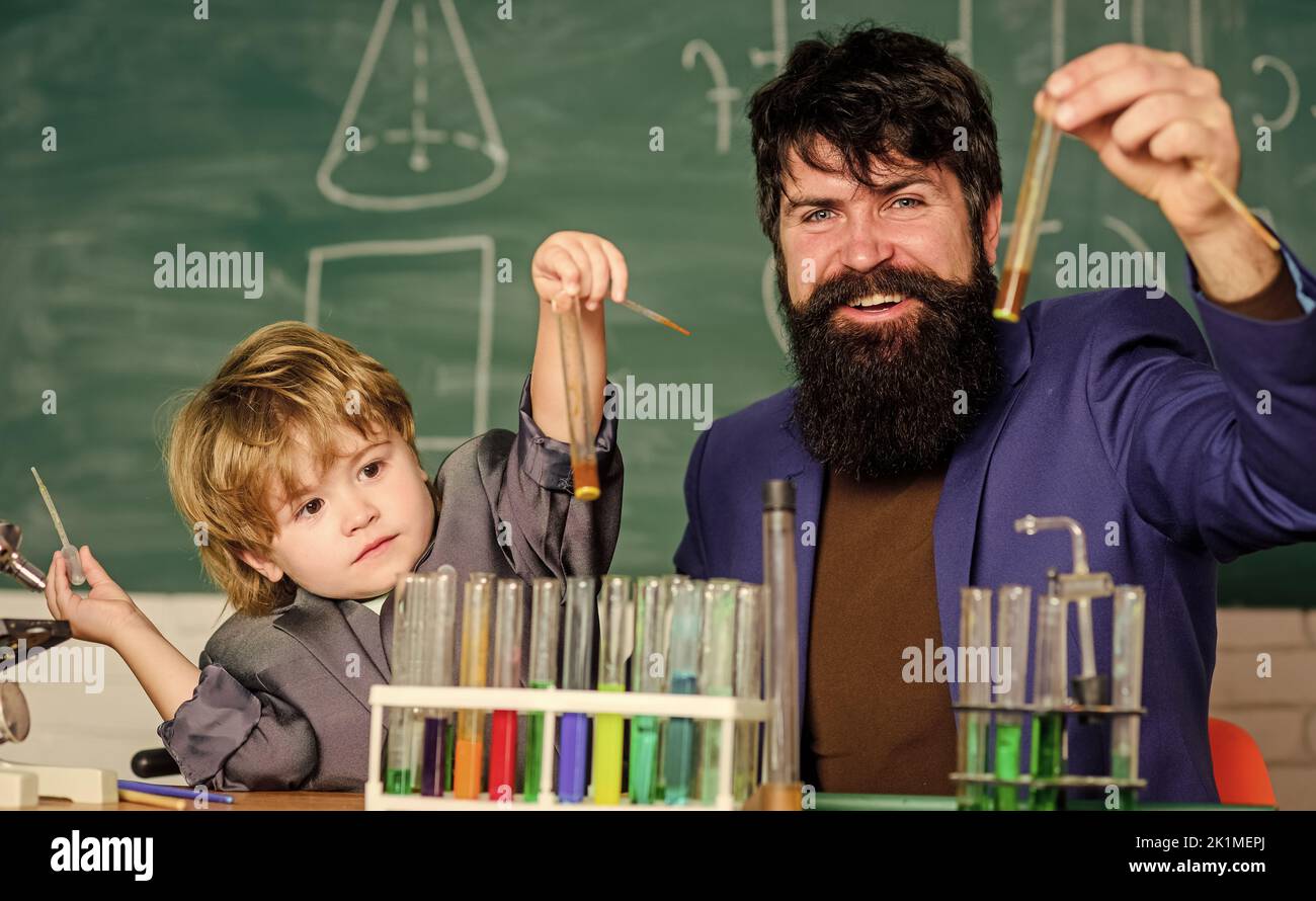 Laboratory experiment. Teacher and pupil boy in chemical laboratory ...