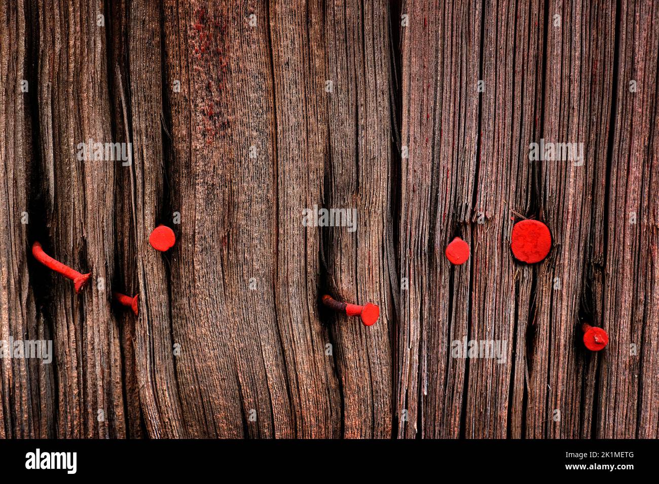 Detail of old weathered wooden barn wall with red paint windows and ...