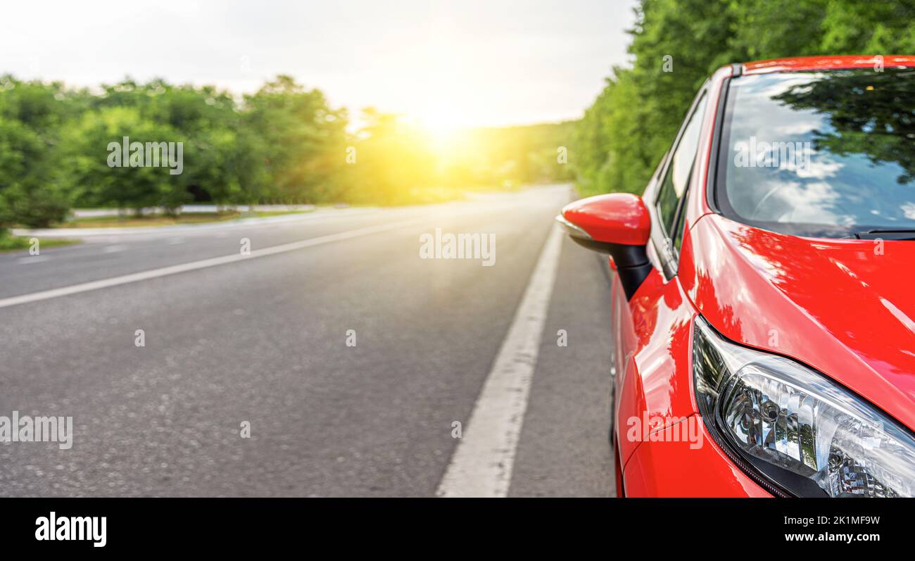 Red car on the road Stock Photo - Alamy