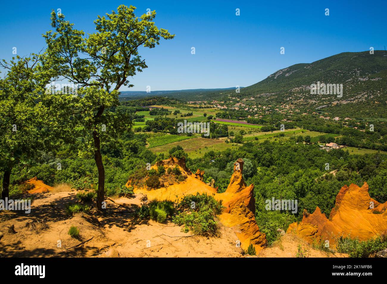 View of Rustrel Village and Bay from the Colourful Ochres of the ...