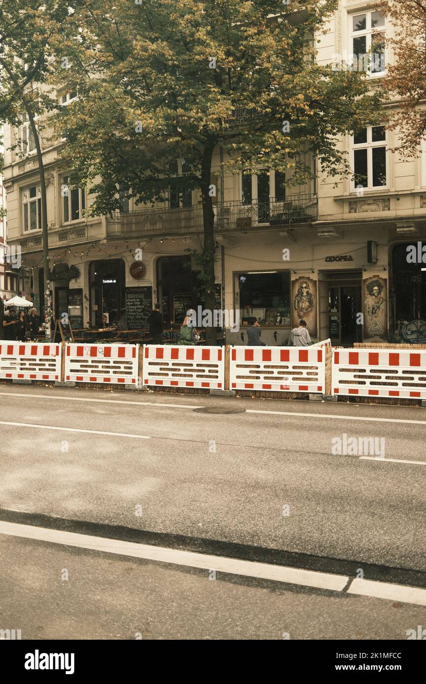 The vertical view of a street before the sidewalk barriers in front of ...