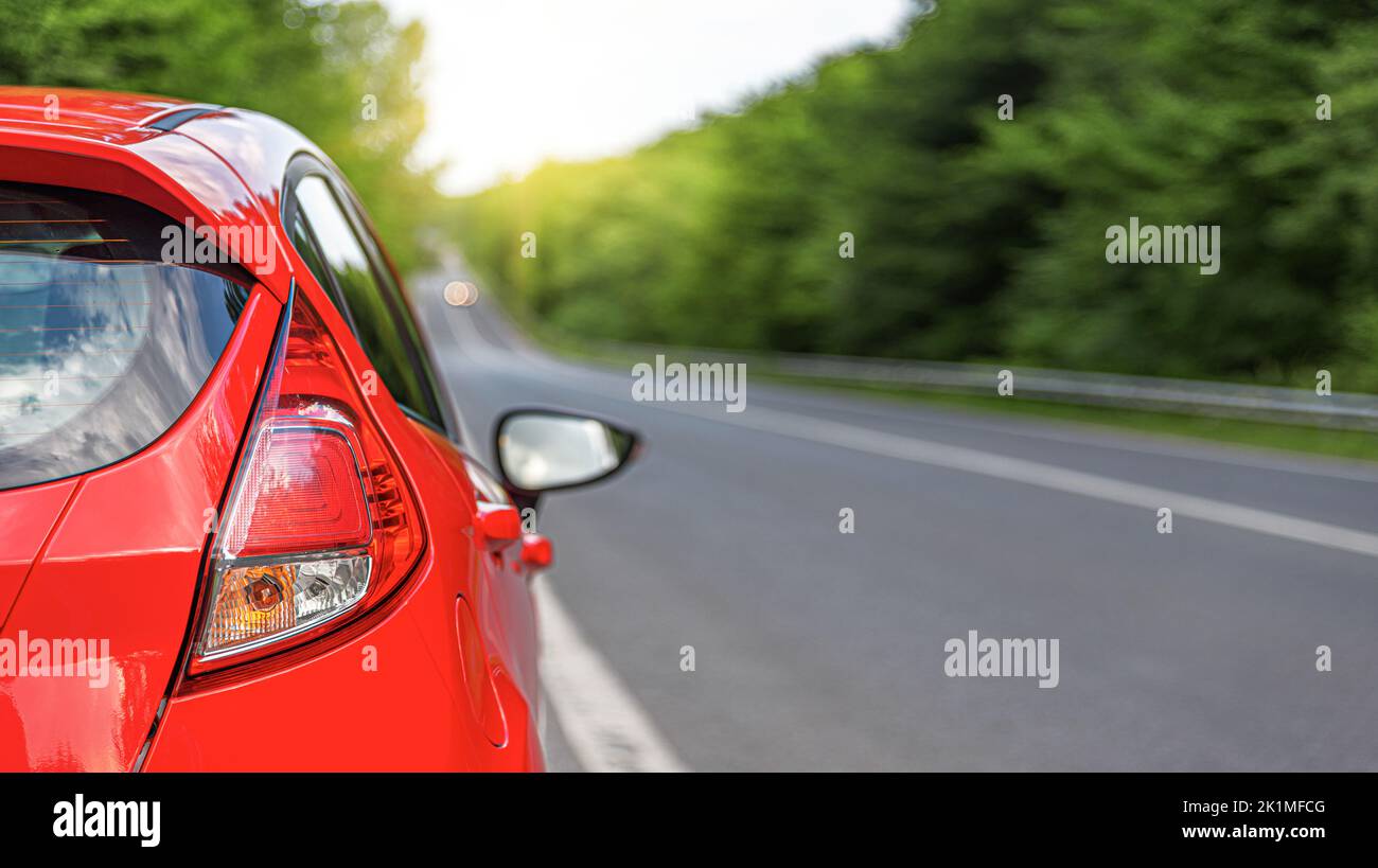 Red car on the road Stock Photo - Alamy