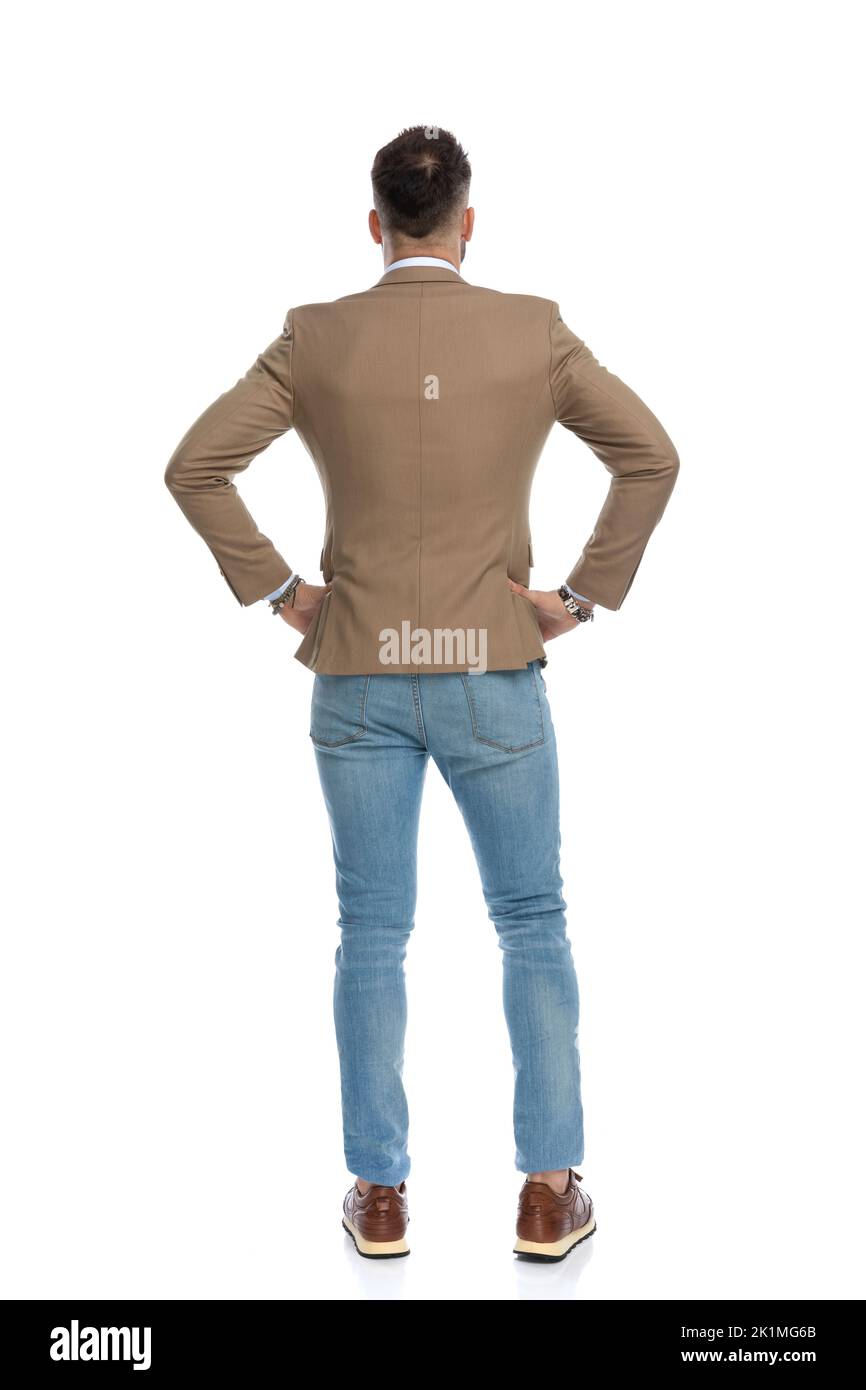 full body picture from back view of man in jacket holding hands on hips ...