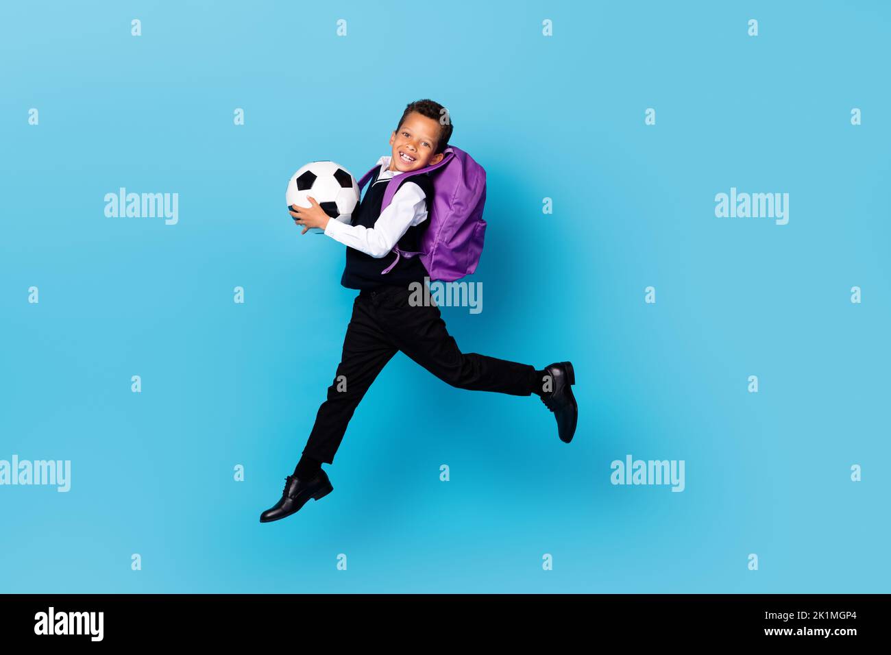 Full size portrait of little person jumping hands hold football ...