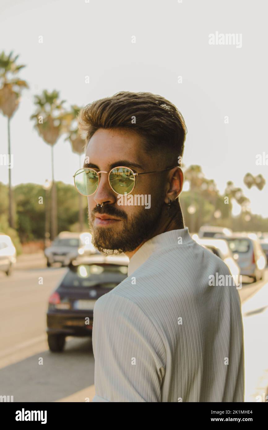 A portrait of a handsome male in white t-shist on the street Stock ...