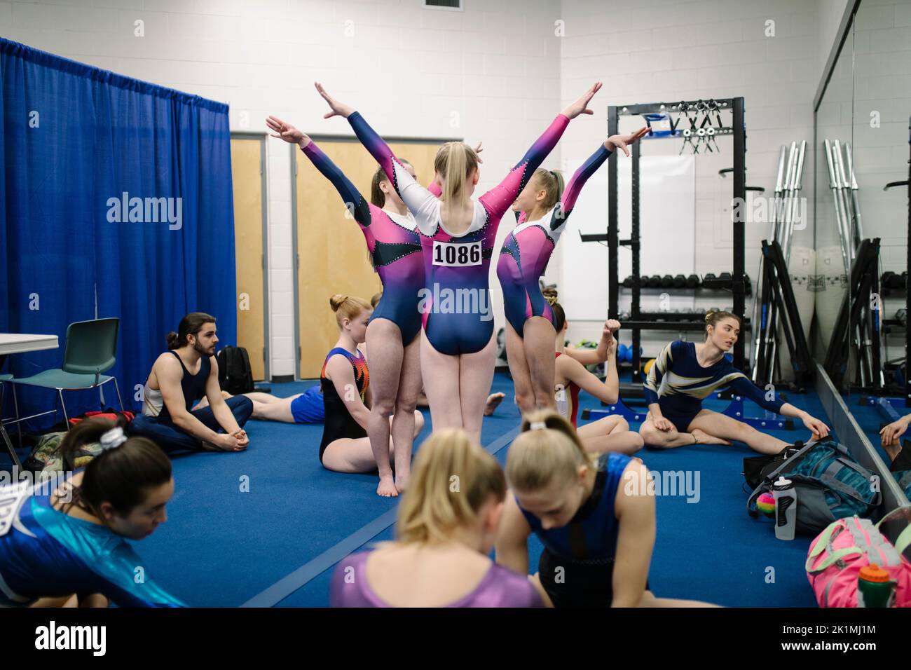 Three female gymnasts practising backstage Stock Photo - Alamy