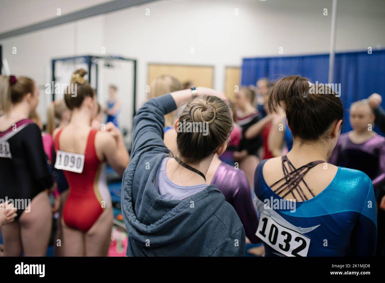 Female gymnasts and coach backstage Stock Photo - Alamy