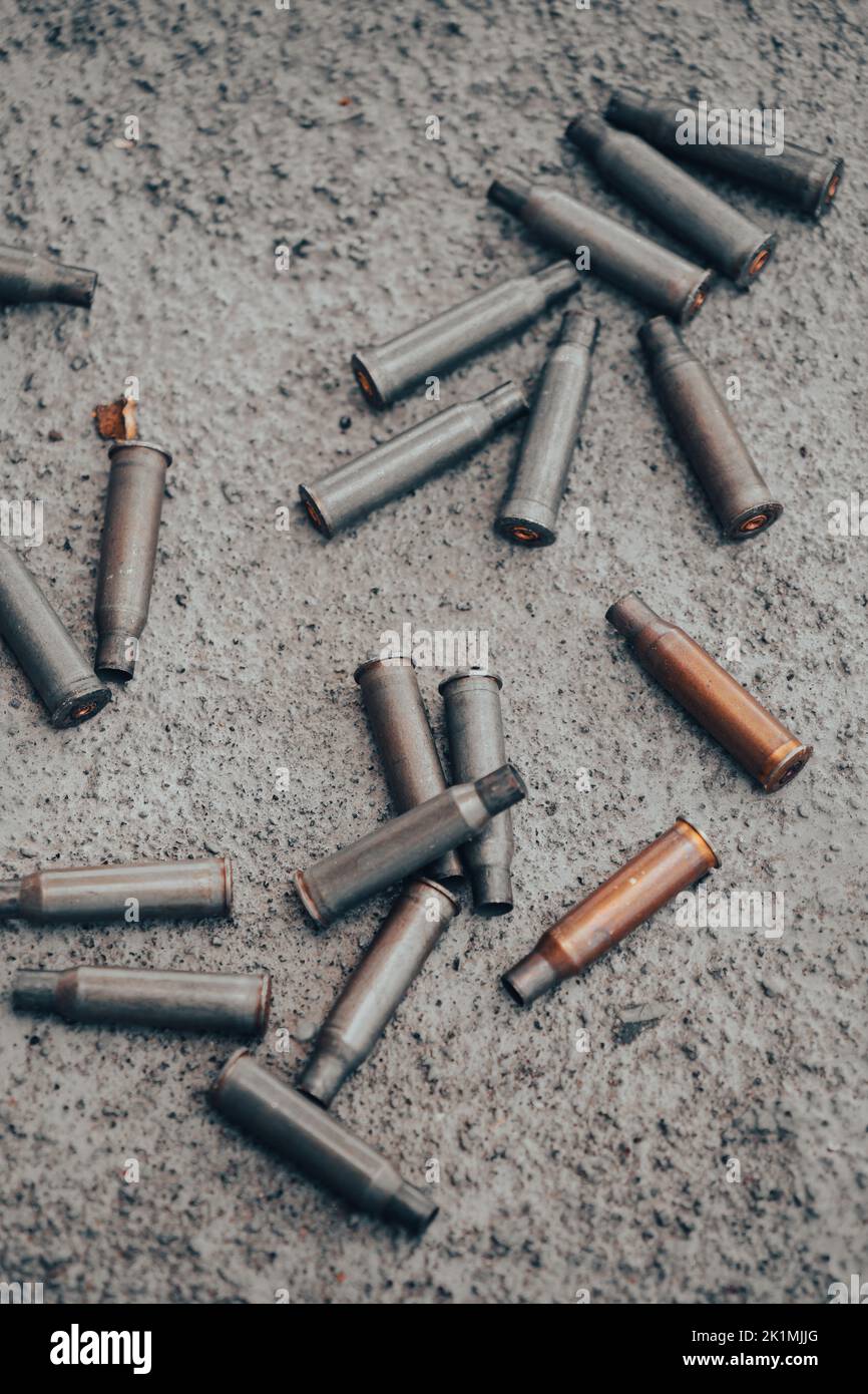 Machine gun empty bullet cartridges lay on the ground after being fired ...