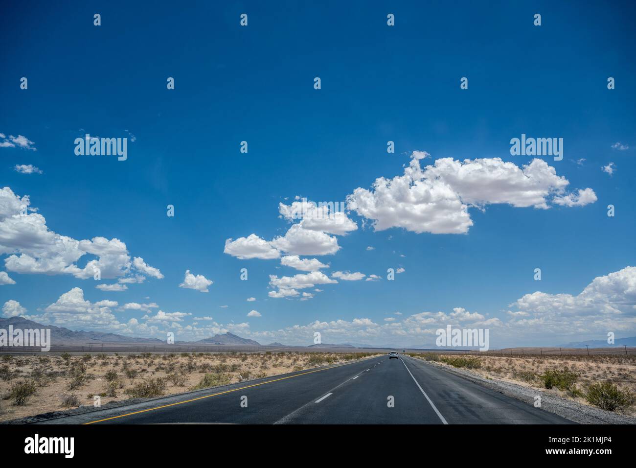 An endless straight paved highway leads through the steppe of Utah USA ...