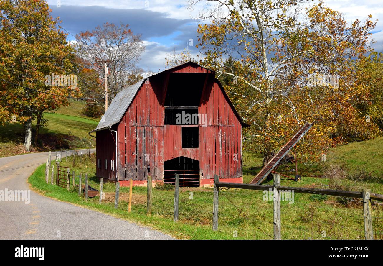Country, wooden, red barn sits in the curve of a Tennessee country road ...
