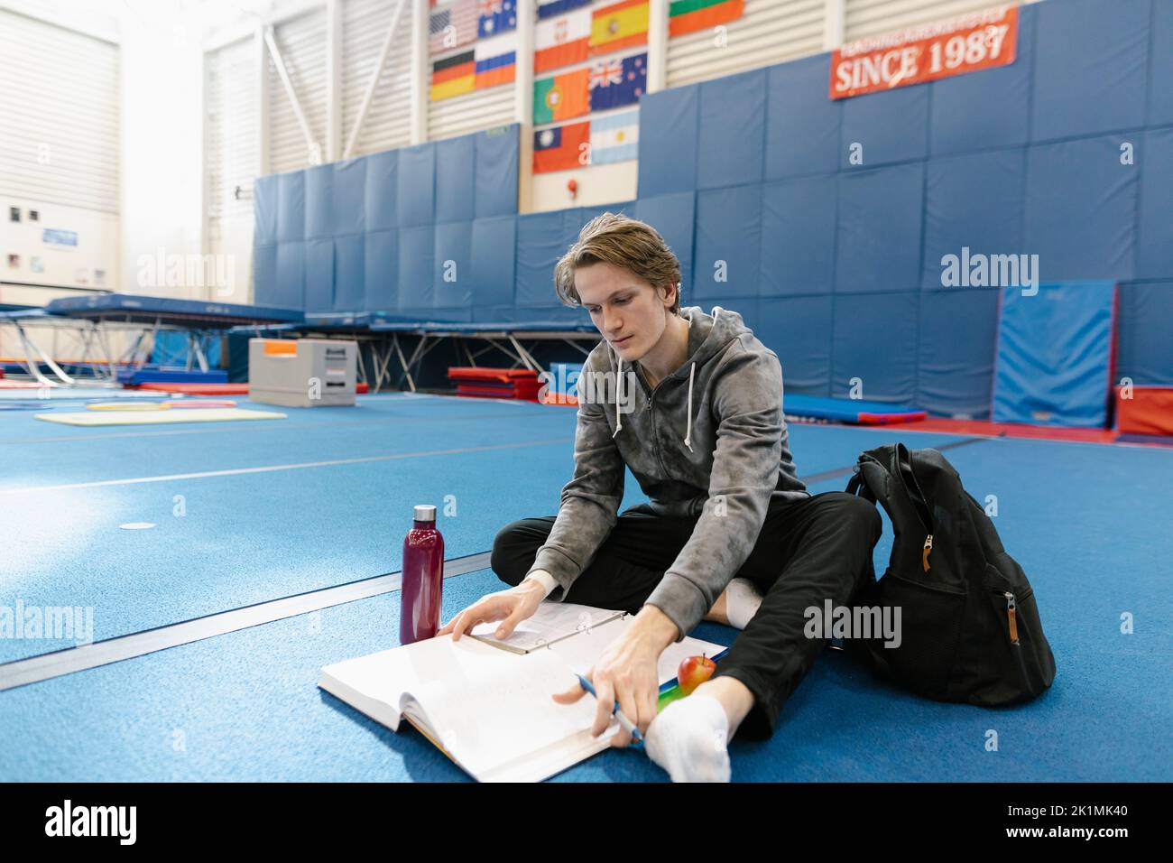 Male athlete studying in gymnasium Stock Photo - Alamy