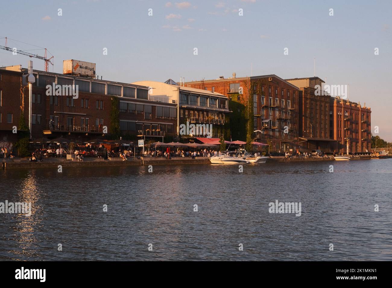 A shot of a lake with the promenade and buildings in the port of ...