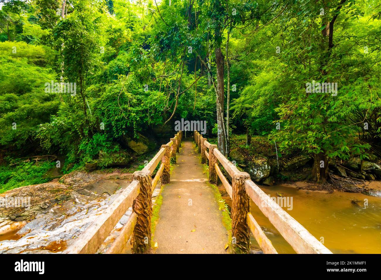 Wooden bridge above the Mae Sa river, near the waterfall, Thailand. Old ...